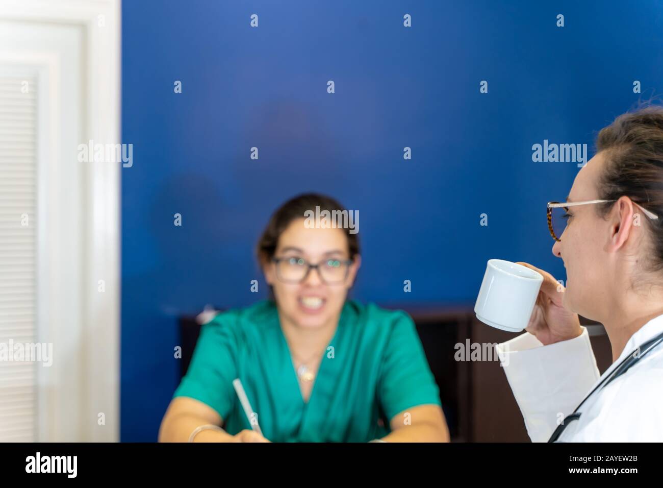 Stock photo of a doctor drinking coffee next to a nurse at a hospital ...