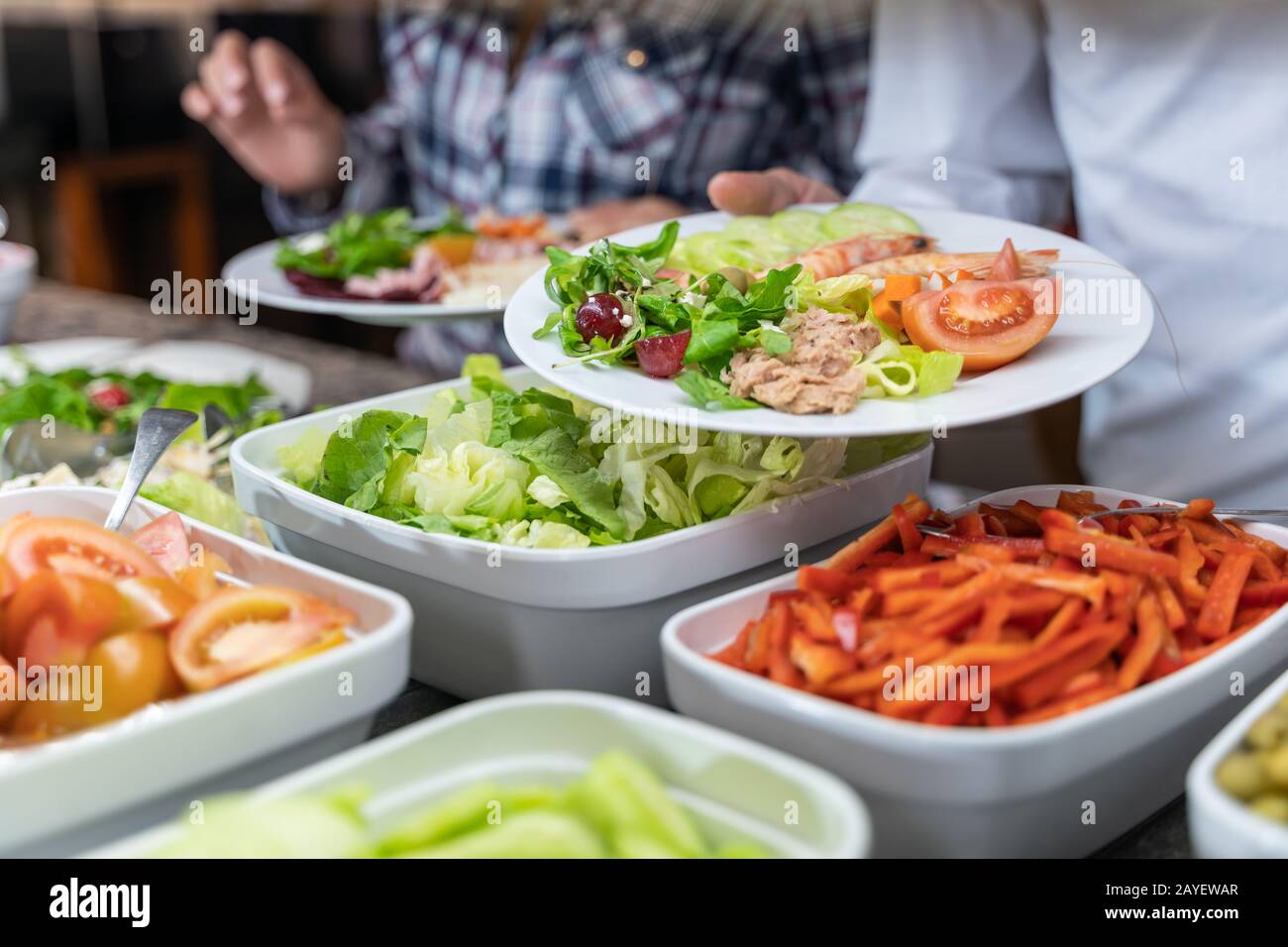 Stock photo of the detail of the hands of a man holding a salad plate ...