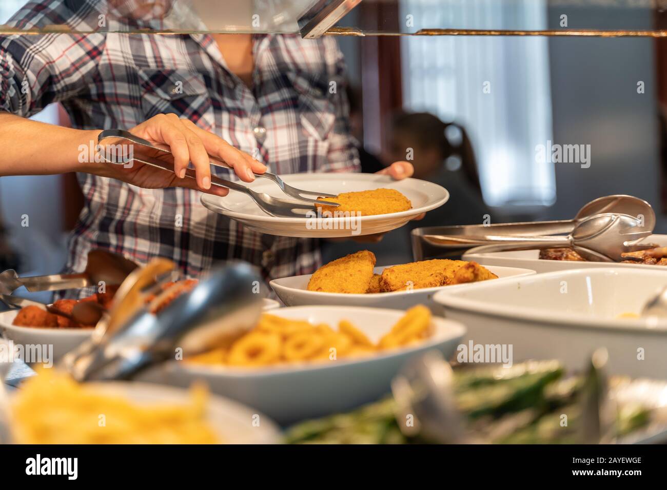 Stock photo of a girl taking food from a self-service. Lifestyle Stock ...