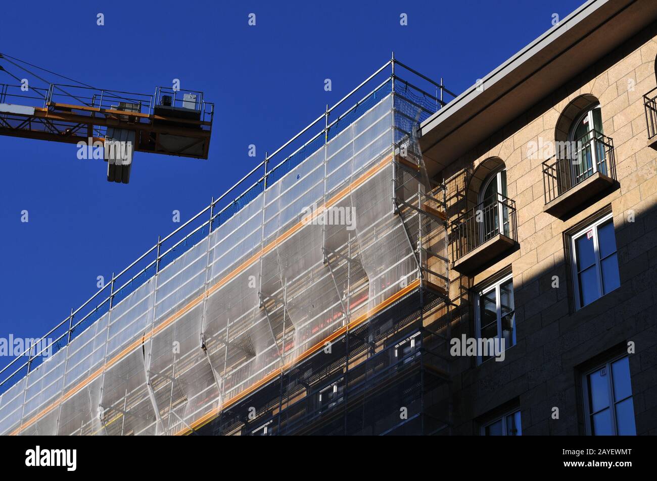 historic facade under renovation with metal scaffold covered with a ...