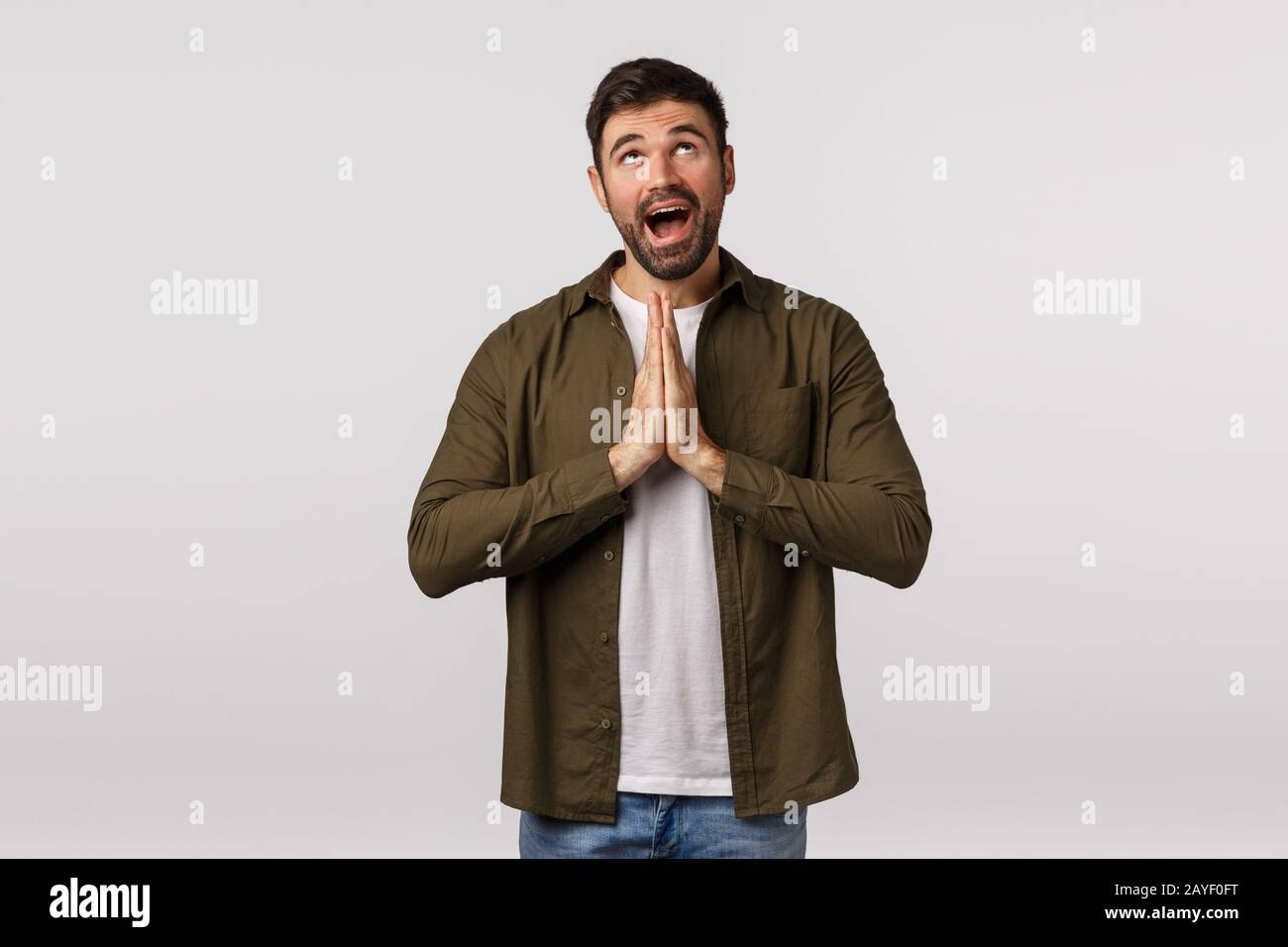 Dreamy, hopeful cute caucasian bearded man believe god, want dream come ...