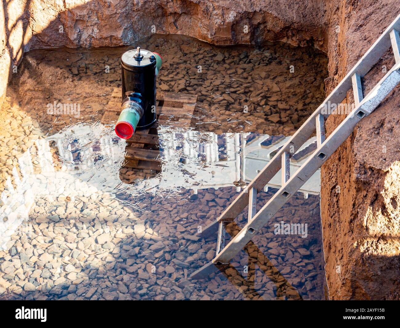 Construction site water pipes after a water pipe break Stock Photo - Alamy