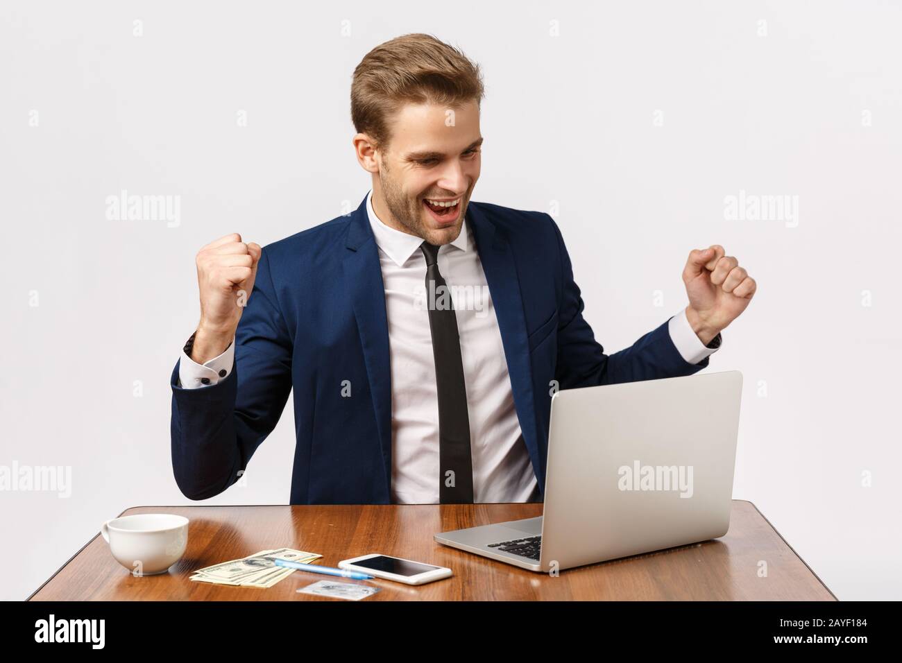 Wow thats a huge win. Attractive young blond man, businessman sitting ...