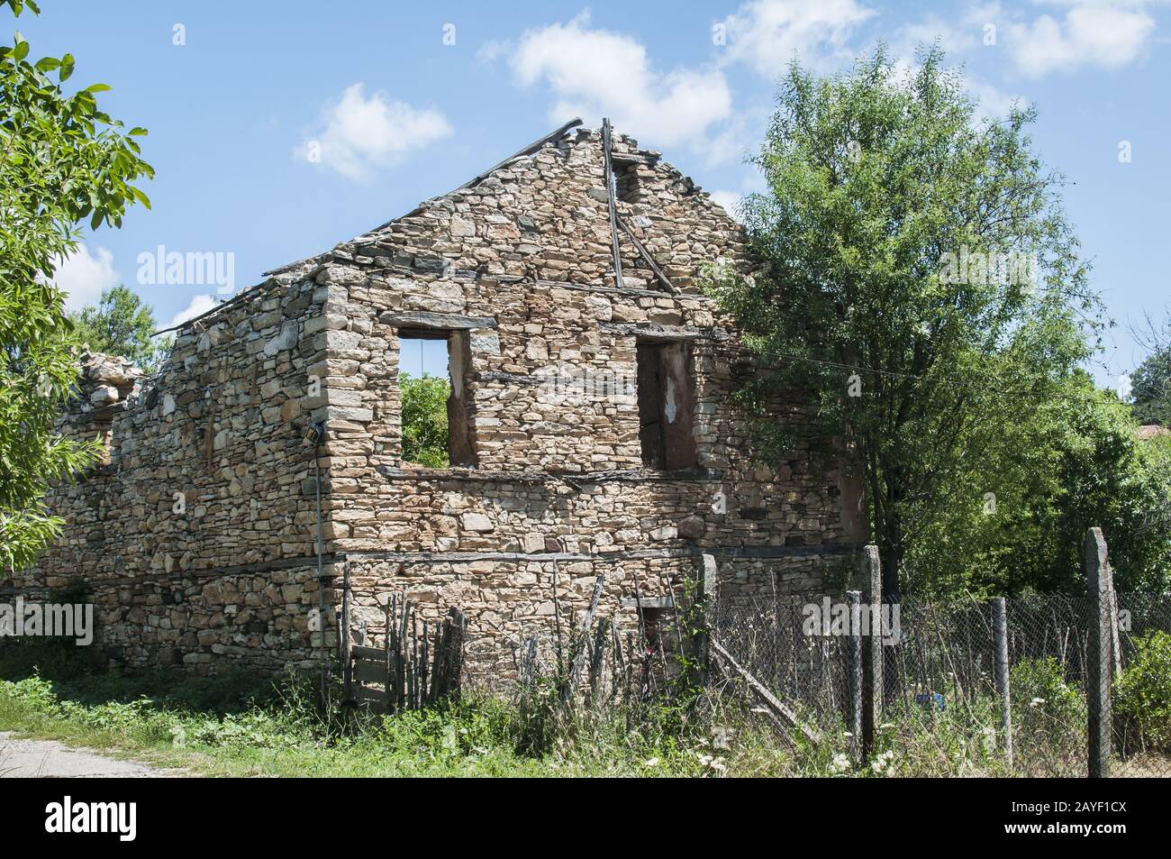 Old destroyed abandoned rural stone house closeup Stock Photo - Alamy