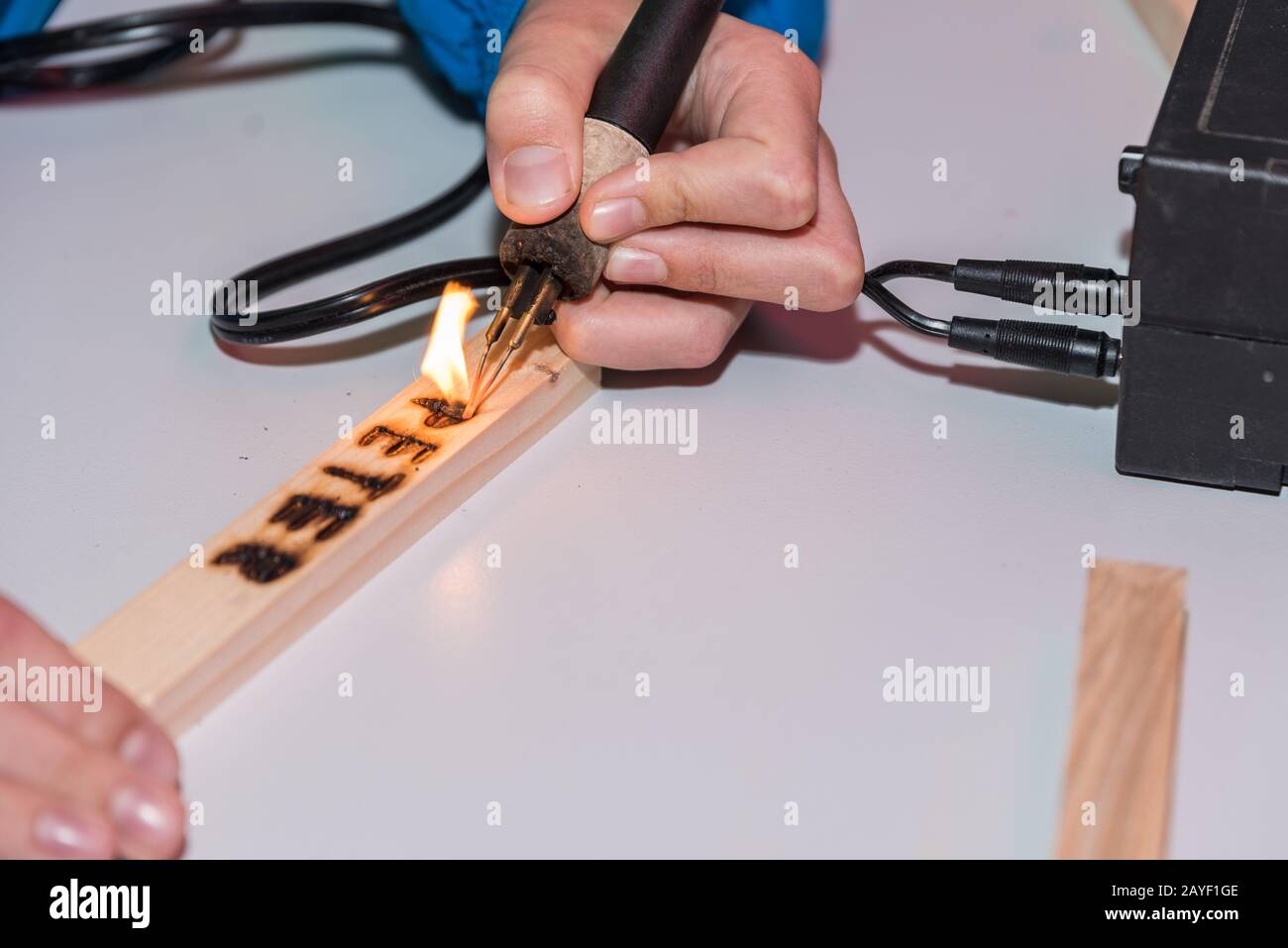 Pyrography caught fire - close-up Stock Photo - Alamy