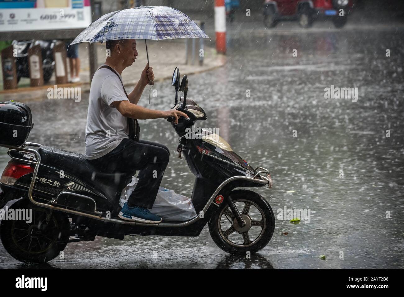Adult riding scooter on pavement hi-res stock photography and images ...
