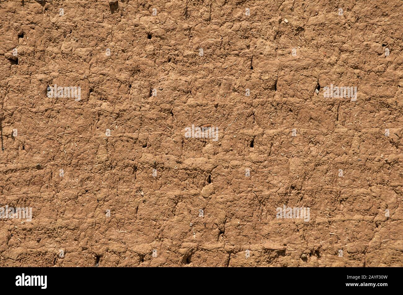 Adobe clay weathered wall of rural vintage country house closeup as ...