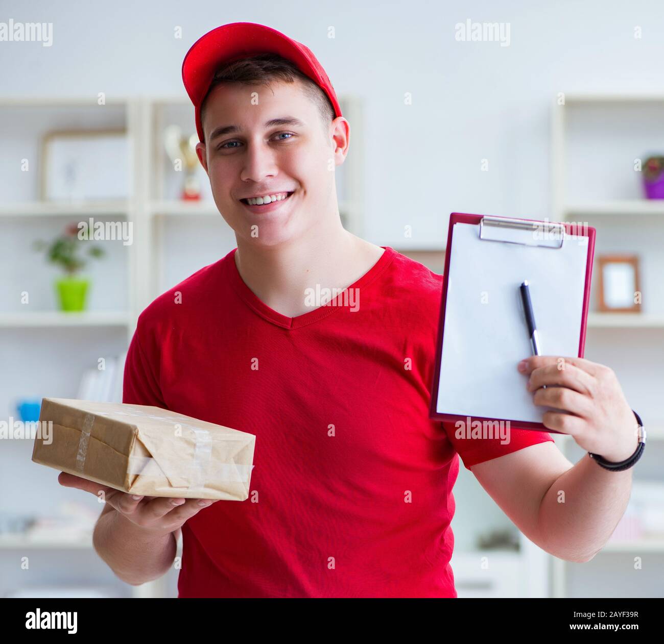 Post man delivering a parcel package Stock Photo - Alamy