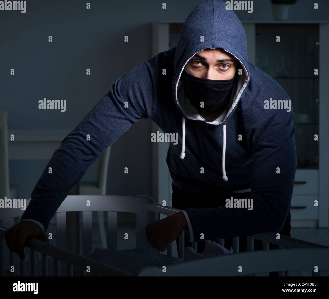 The criminal stealing baby in human child traficking concept Stock ...