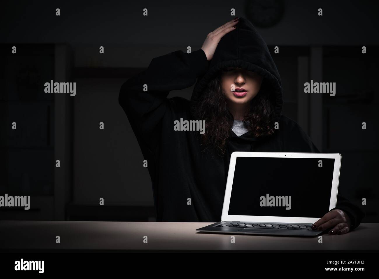 Female hacker hacking security firewall late in office Stock Photo - Alamy