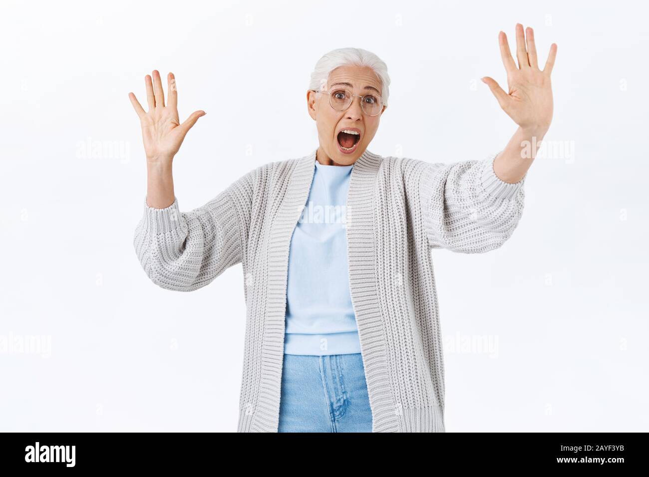 Scared and shocked old lady being frightened by grandchild jumping from ...