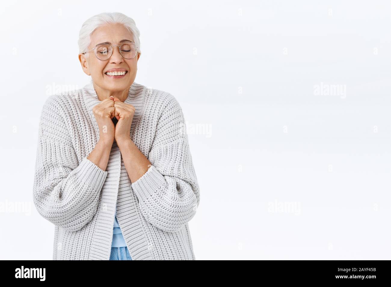 Dreamy, cheerful old woman, senior lady feeling affection and joy as ...