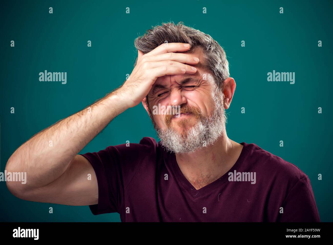 A portrait of sad bearded man in red t-shirt. People and emotions ...
