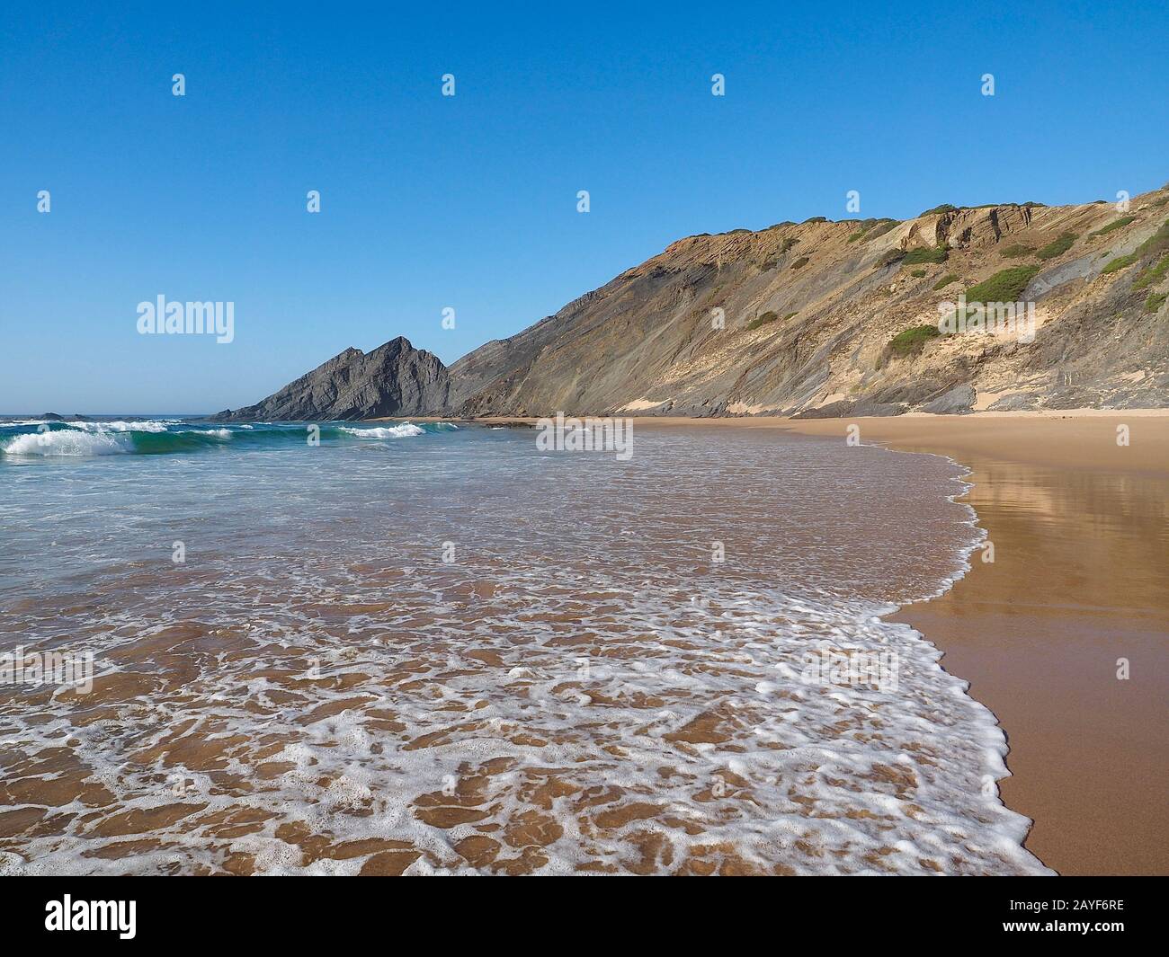 Beautiful mountains at the famous paradise beach Praia da Amoreira near ...