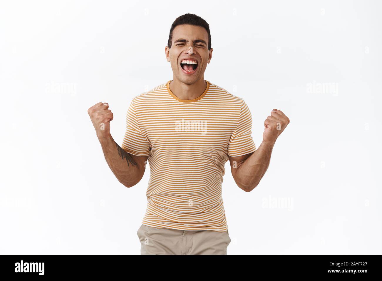 Pumped happy guy achieve success, celebrating, shouting from happiness ...