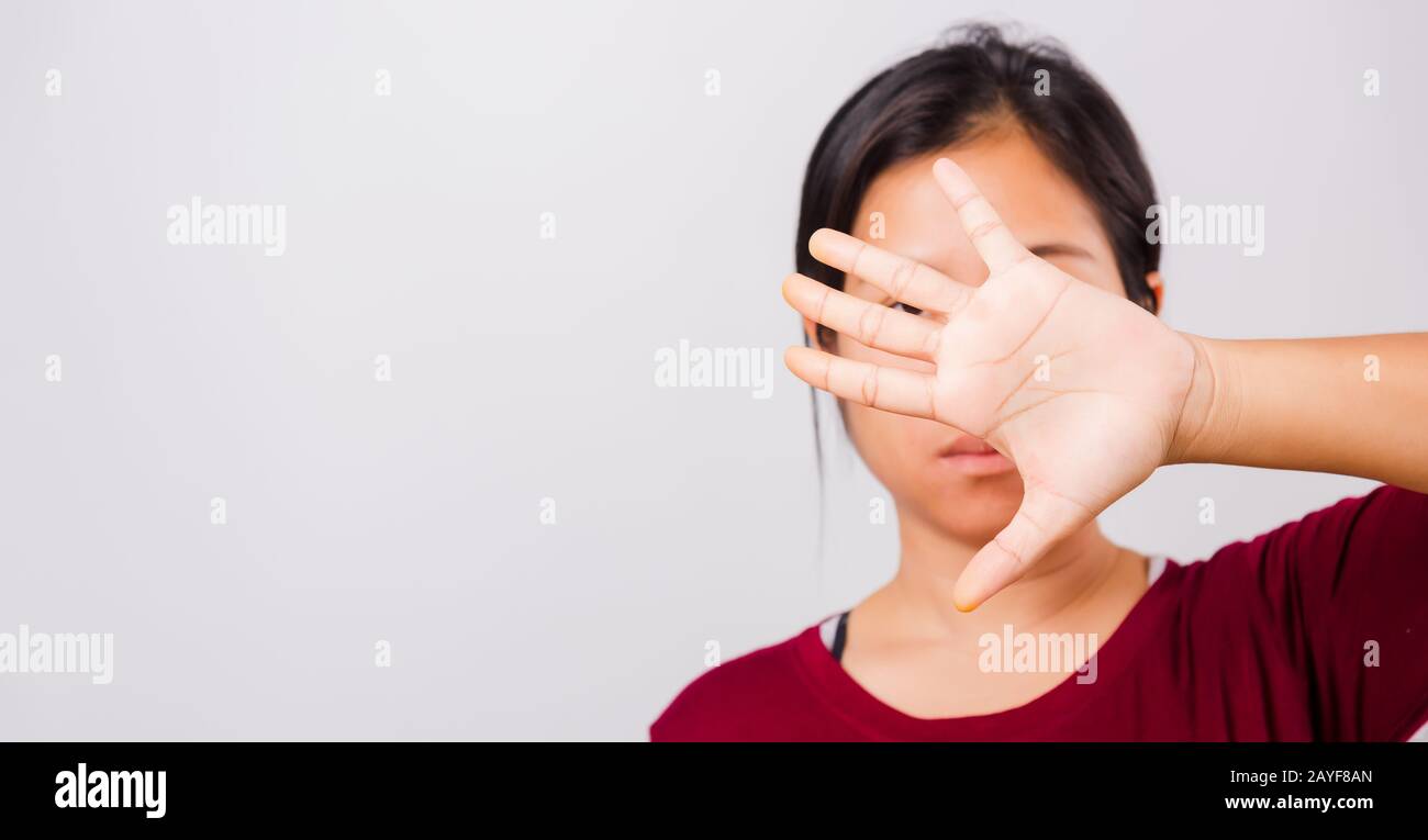 Asian beautiful woman itching her outstretched hand showing stop ... Asian beautiful woman itching her outstretched hand showing stop ...