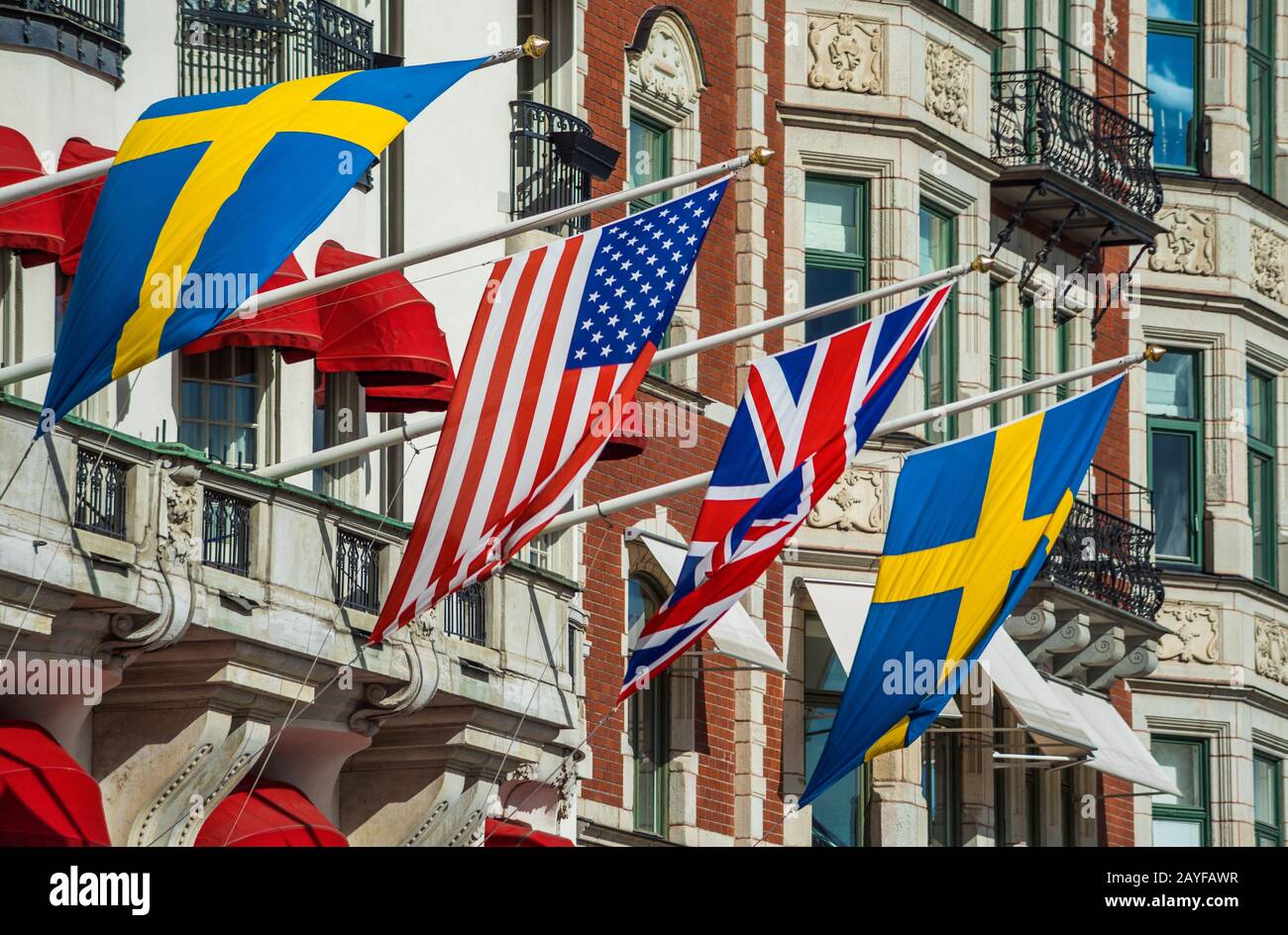 Flags of Great Britain, USA and Sweden on the facade of the hotel Stock ...