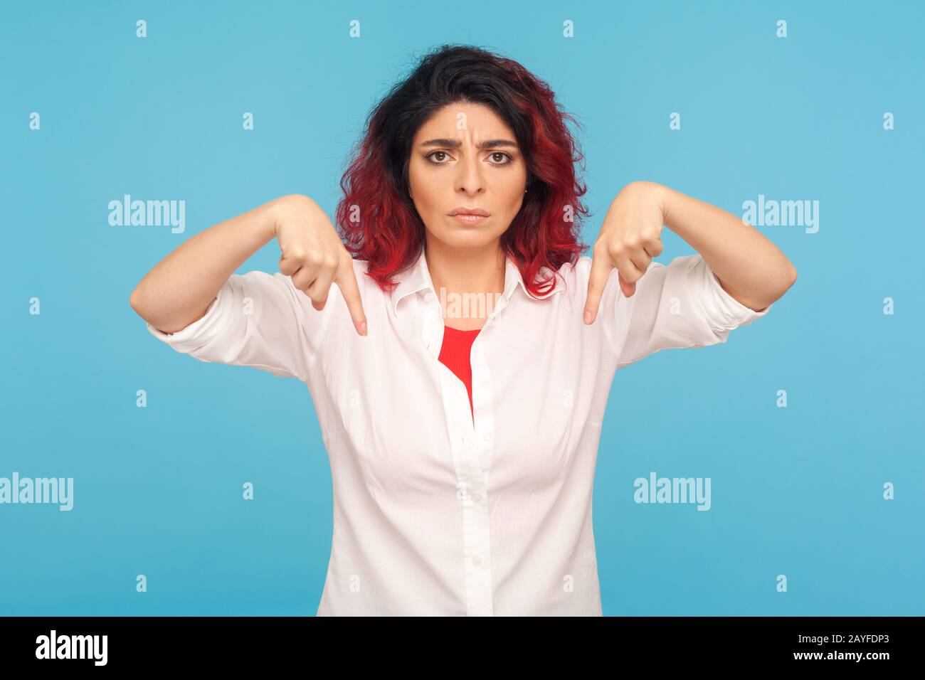 Here and right now! Portrait of angry woman with fancy red hair in ...