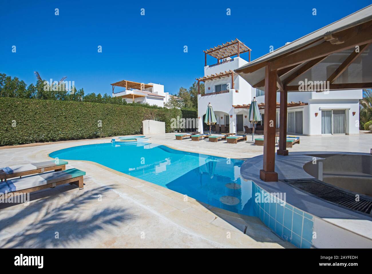 Luxury villa show home in tropical summer holiday resort with swimming ...