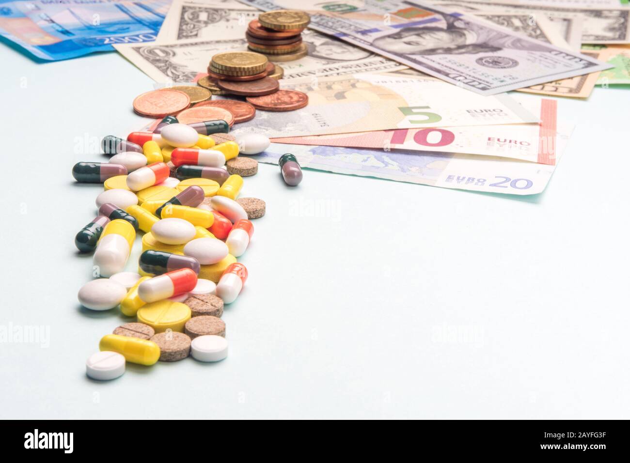 tablets, capsules next to banknotes and coins. high costs for buy of ...