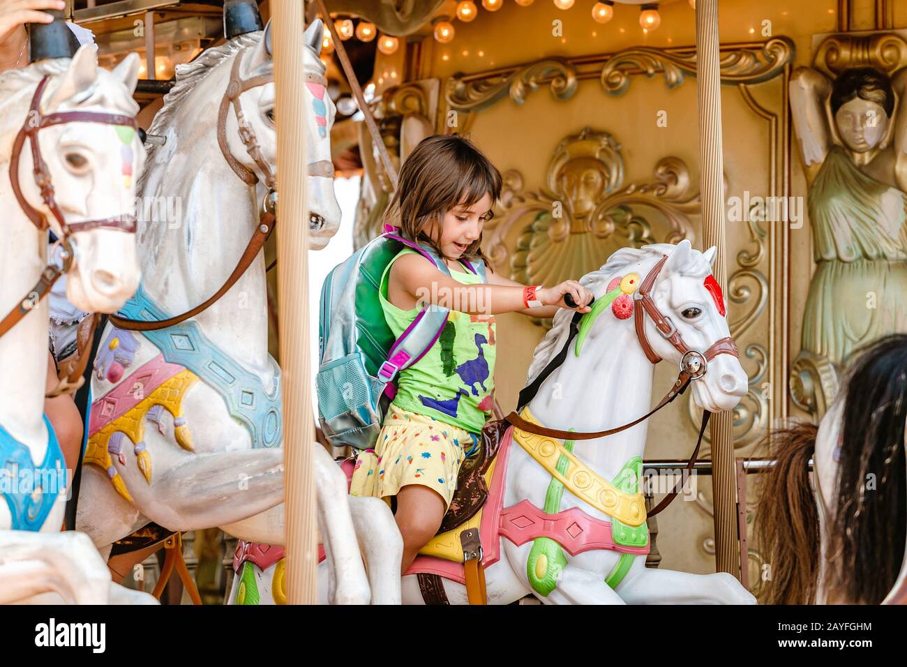 Young girl riding carousel horse hi-res stock photography and images ...