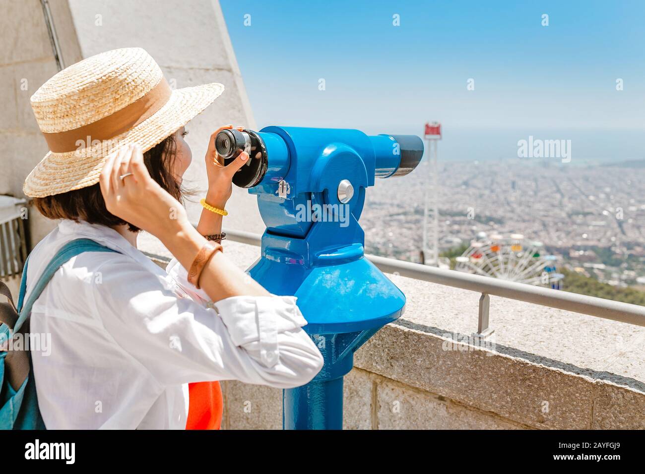 Happy woman sightseeing in city vacation using telescope viewer Stock ...
