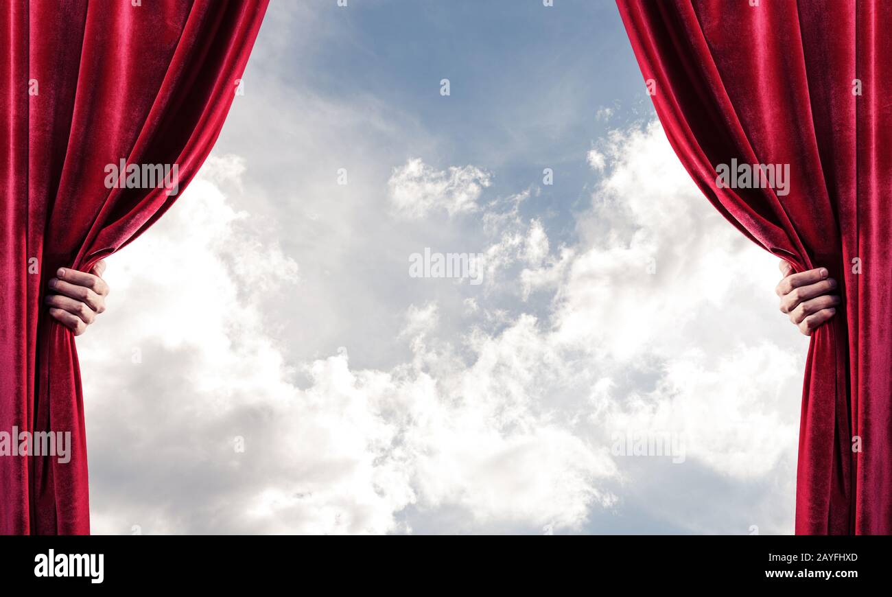 Cloudy landscape behind red curtain and hand holding it Stock Photo - Alamy