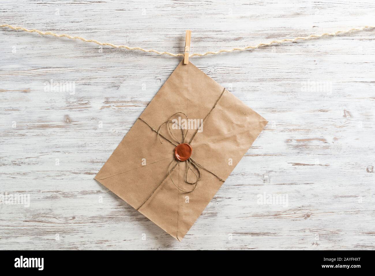 Old paper envelope hanging on rope Stock Photo - Alamy