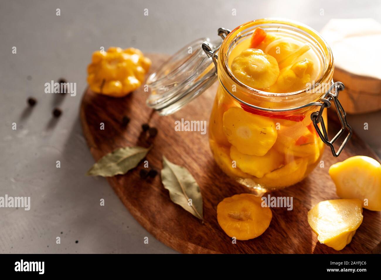 Fermented yellow squash vegetable in a glass jar. The concept of canned ...