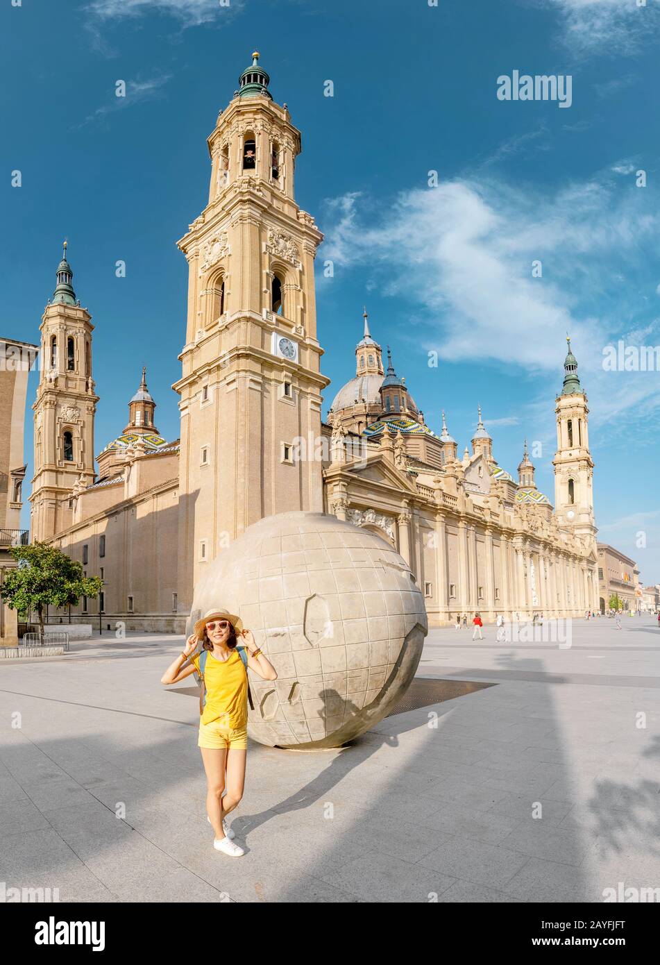 Young happy woman tourist walking near the famous cathedral Del Pilar ...