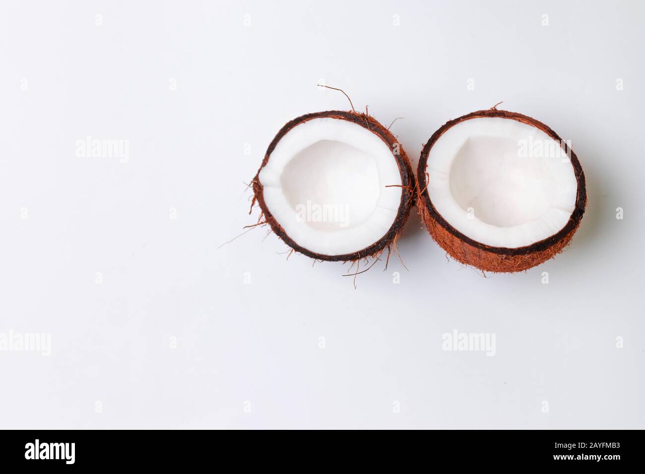 Top view of two halves of coconut on a gray background Stock Photo - Alamy