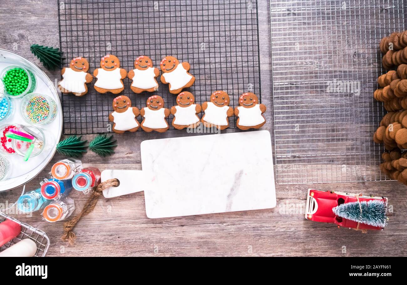 Flat lay. Decorating gingerbread cookies with royal icing Stock Photo ...
