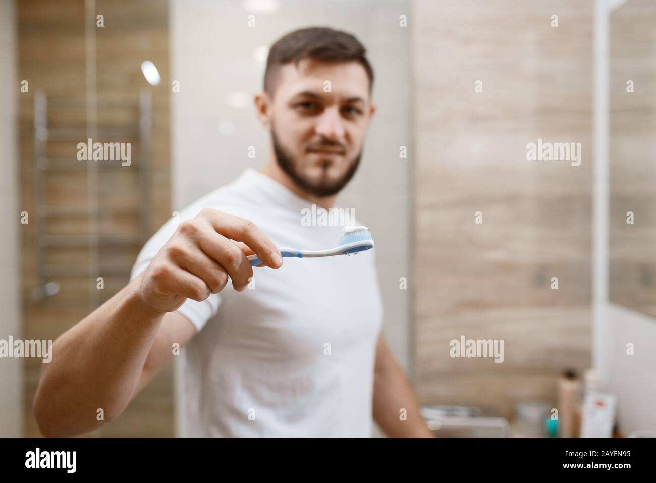 Man brushes his teeth in bathroom, morning hygiene Stock Photo - Alamy