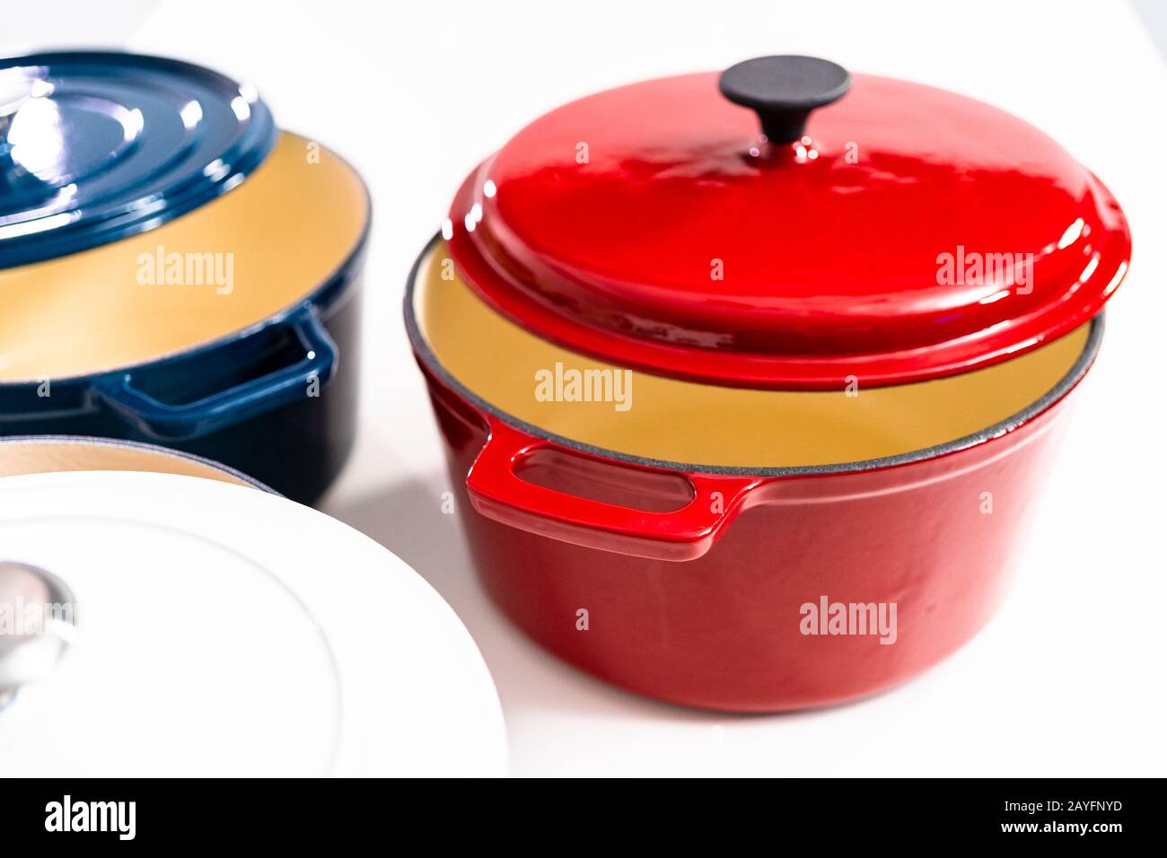 Red, white and blue enameled cast iron covered round dutch ovens on a ...