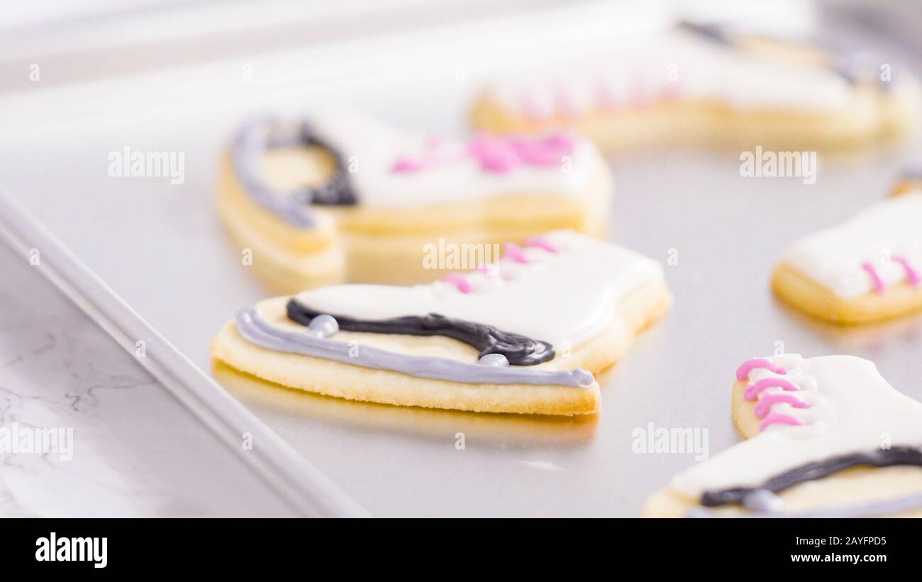 Icing figure skate shaped sugar cookies with royal icing Stock Photo ...