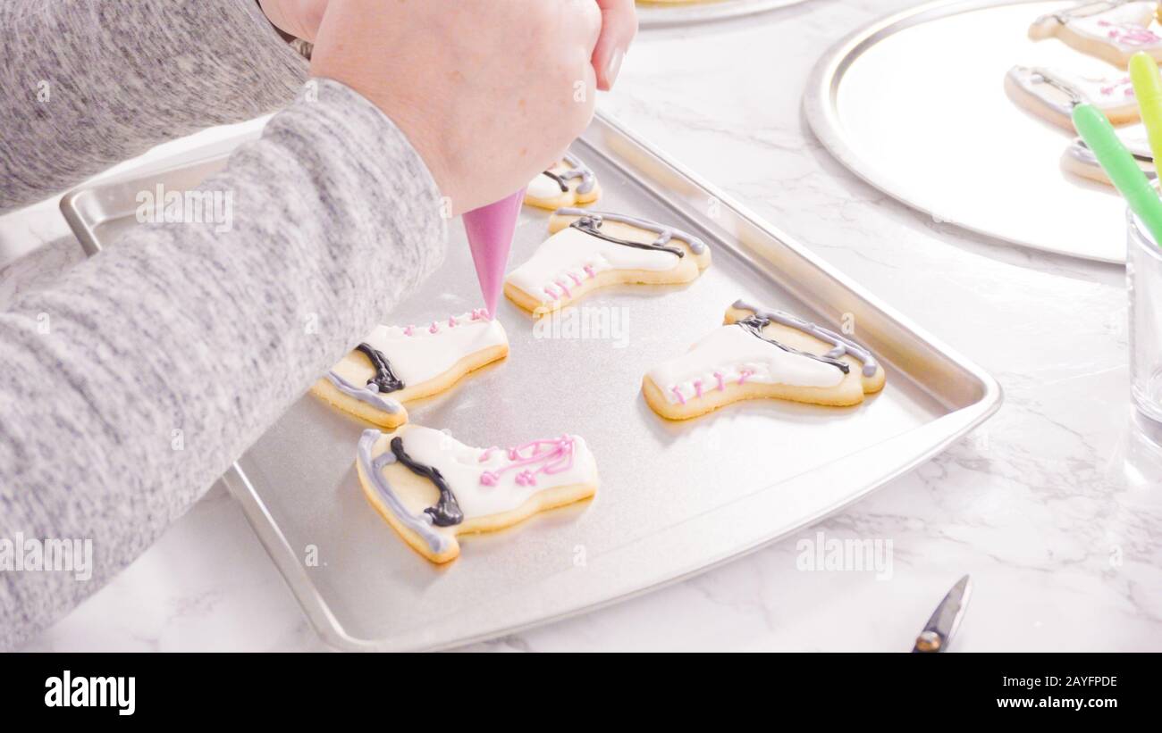 Icing figure skate shaped sugar cookies with royal icing Stock Photo ...