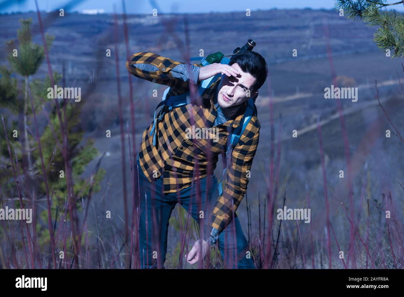 abnormal phenomenon outdoors. man hiking alone in the wild and seeing ...