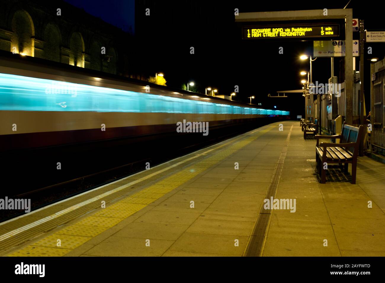 night time long exposure picture of an Underground train speeding past ...