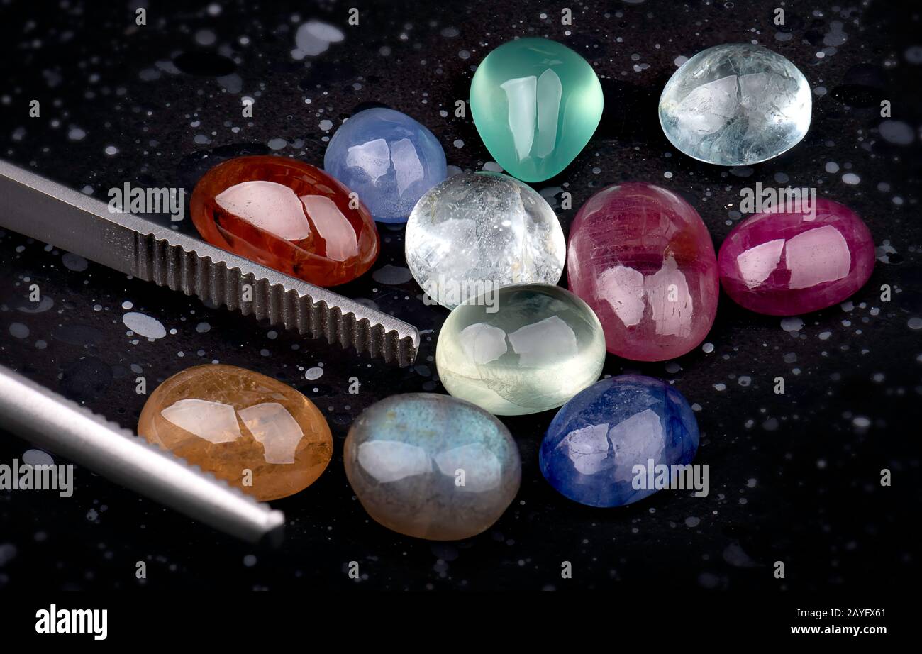 Mix Round cut mineral gemstones with dark stones background Stock Photo ...