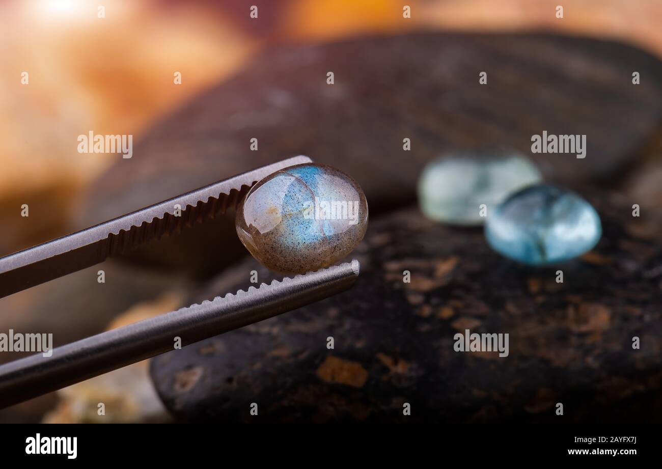 Round cut labradorite mineral gemstones with dark stones background ...