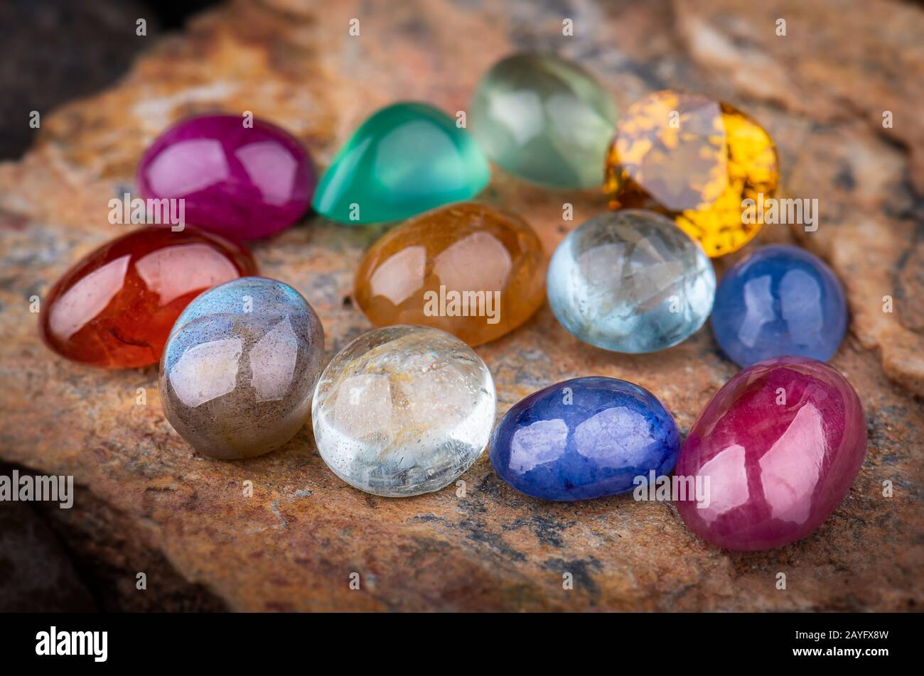 Mix Round cut mineral gemstones with dark stones background Stock Photo ...