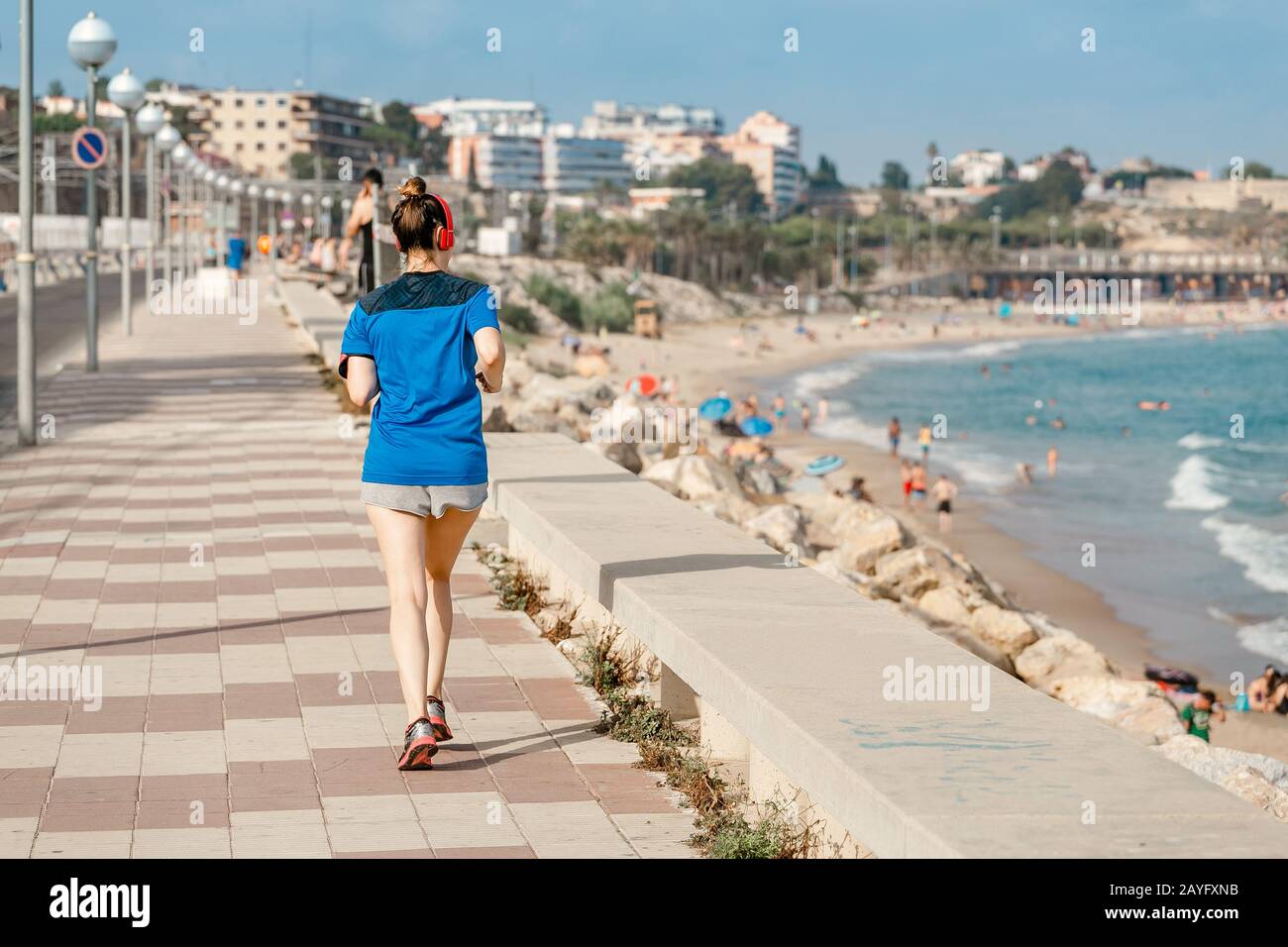 healthy lifestyle sports person running along seaside Stock Photo - Alamy