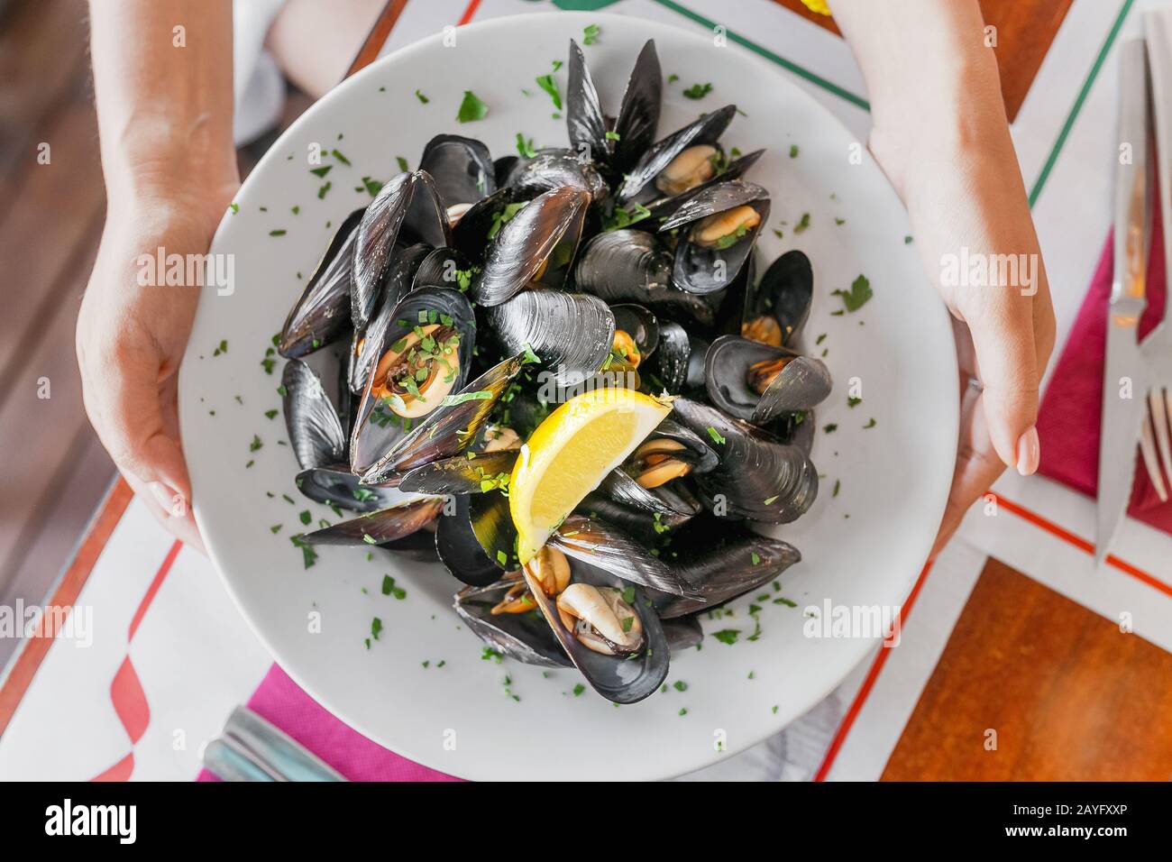 Woman eating sea mussels hi-res stock photography and images - Alamy