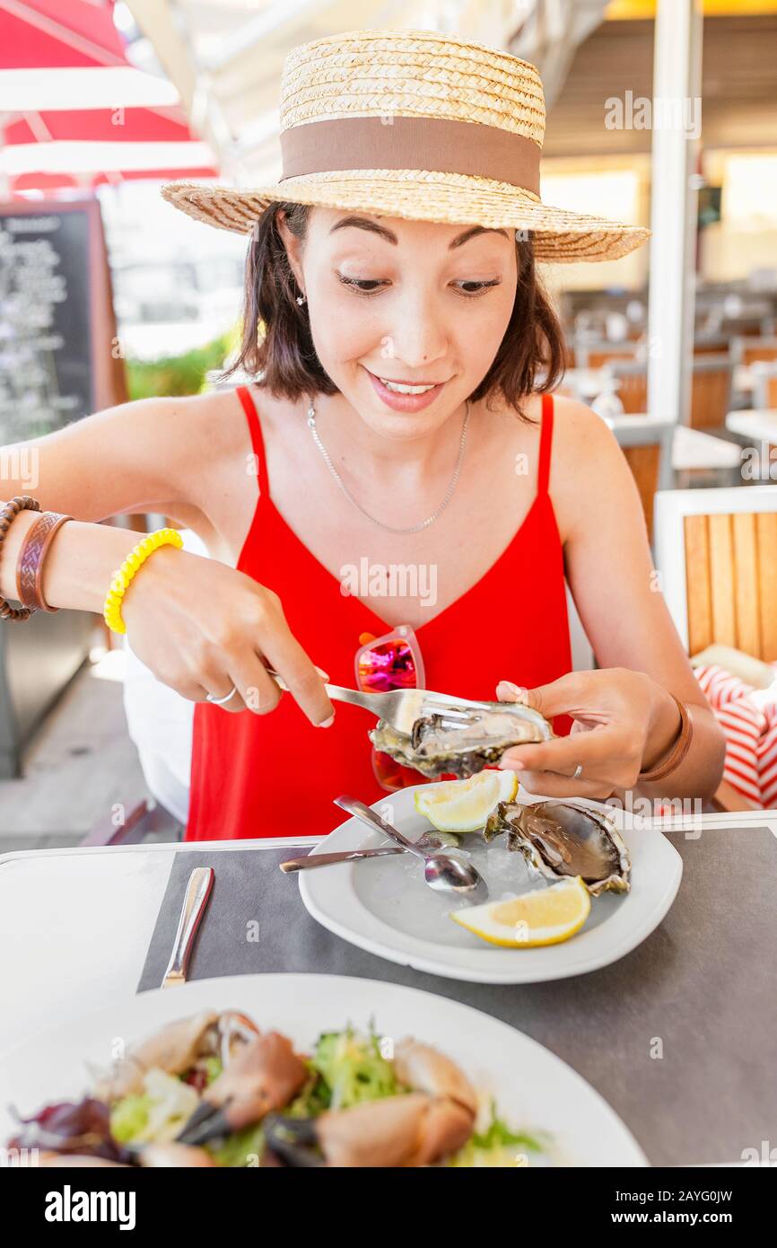 Woman holding seafood plate hi-res stock photography and images - Alamy