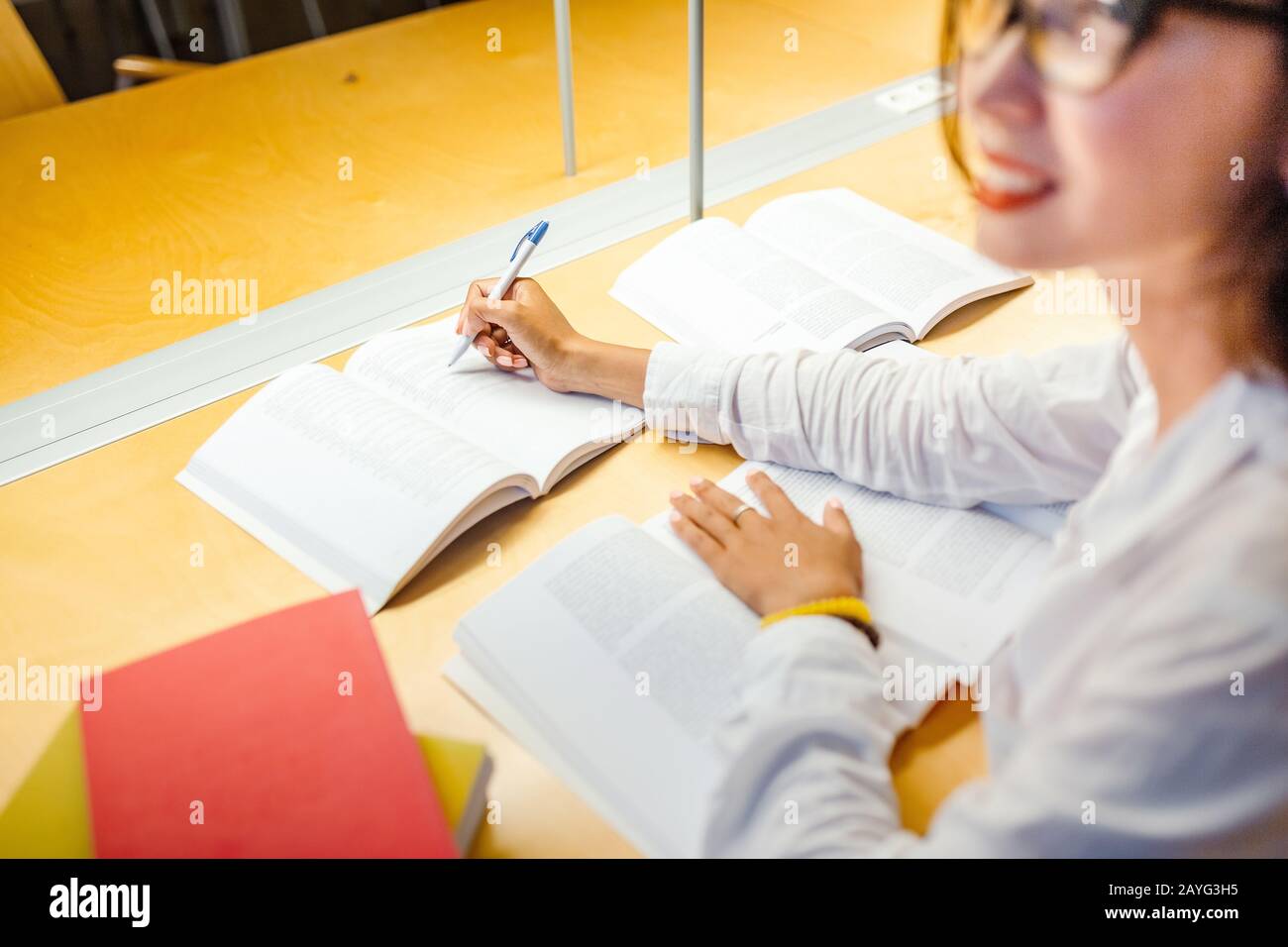 happy asian girl student doing homework in library Stock Photo - Alamy