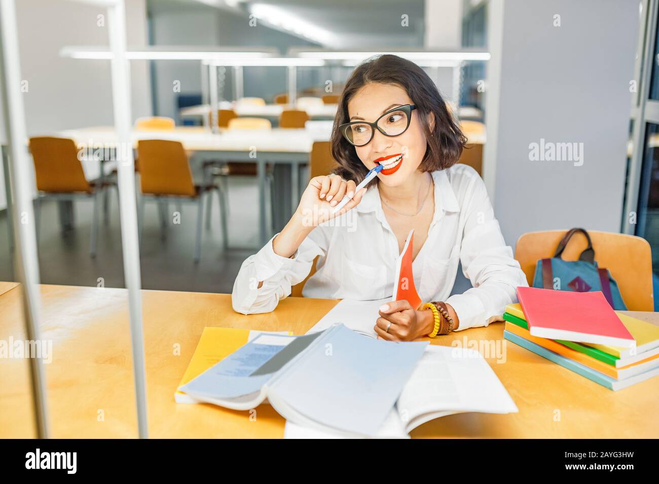 happy asian girl student doing homework in library Stock Photo - Alamy