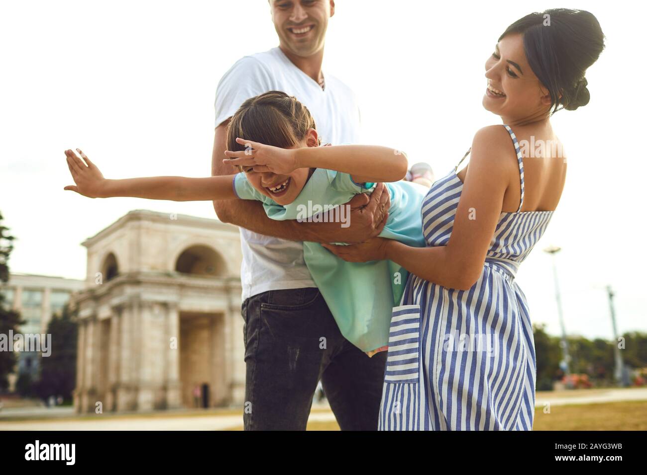 Happy smiling family walking on the street Stock Photo - Alamy