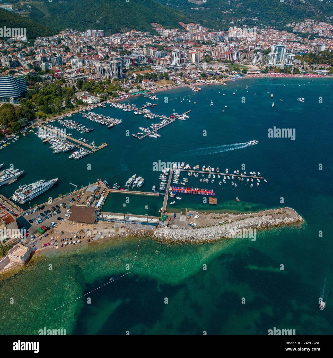 Aerial view of boats moored at the Budva Harbour, Montenegro. Modern ...