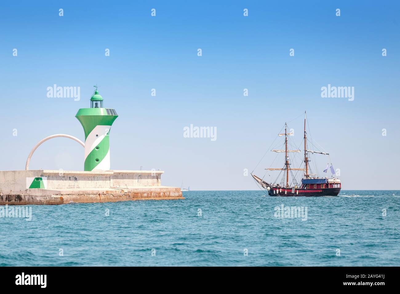 Pirate ship and lighthouse Stock Photo - Alamy