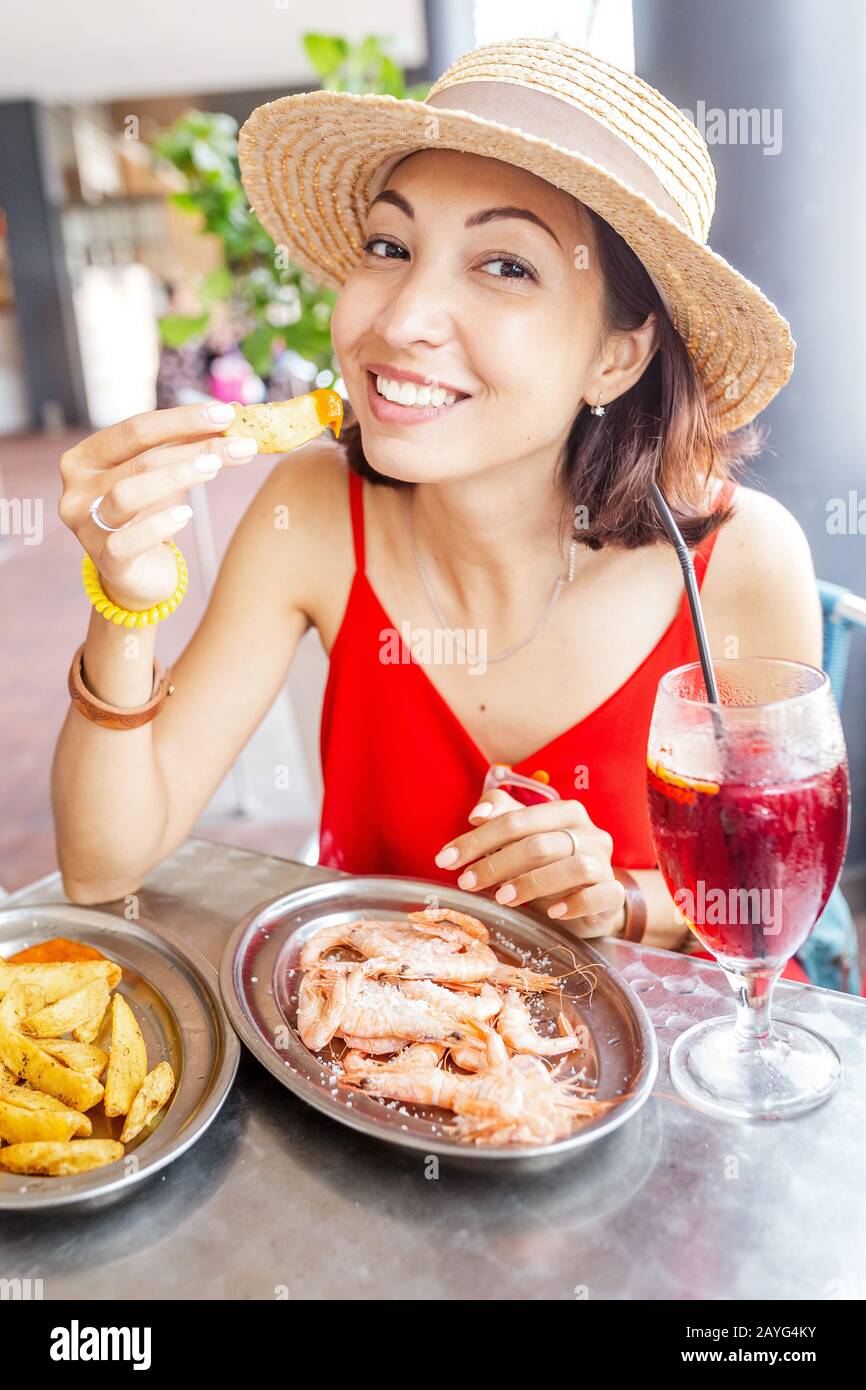Woman serving seafood plate hi-res stock photography and images - Alamy